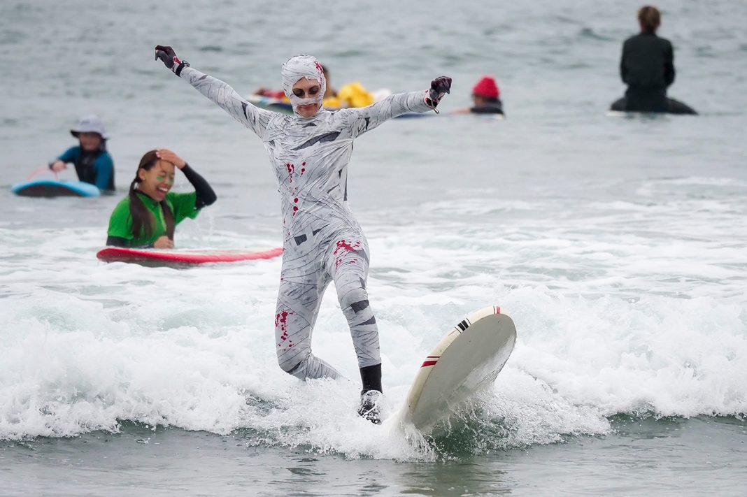 Costumed Surfers Hit the Waves for Annual Blackies Halloween Surf Event ...